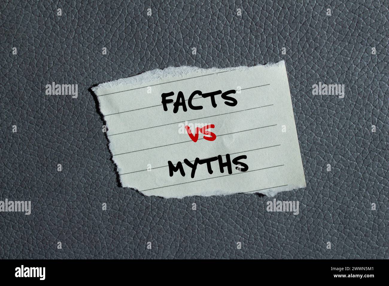 Facts vs myths words written on torn paper piece with gray background ...