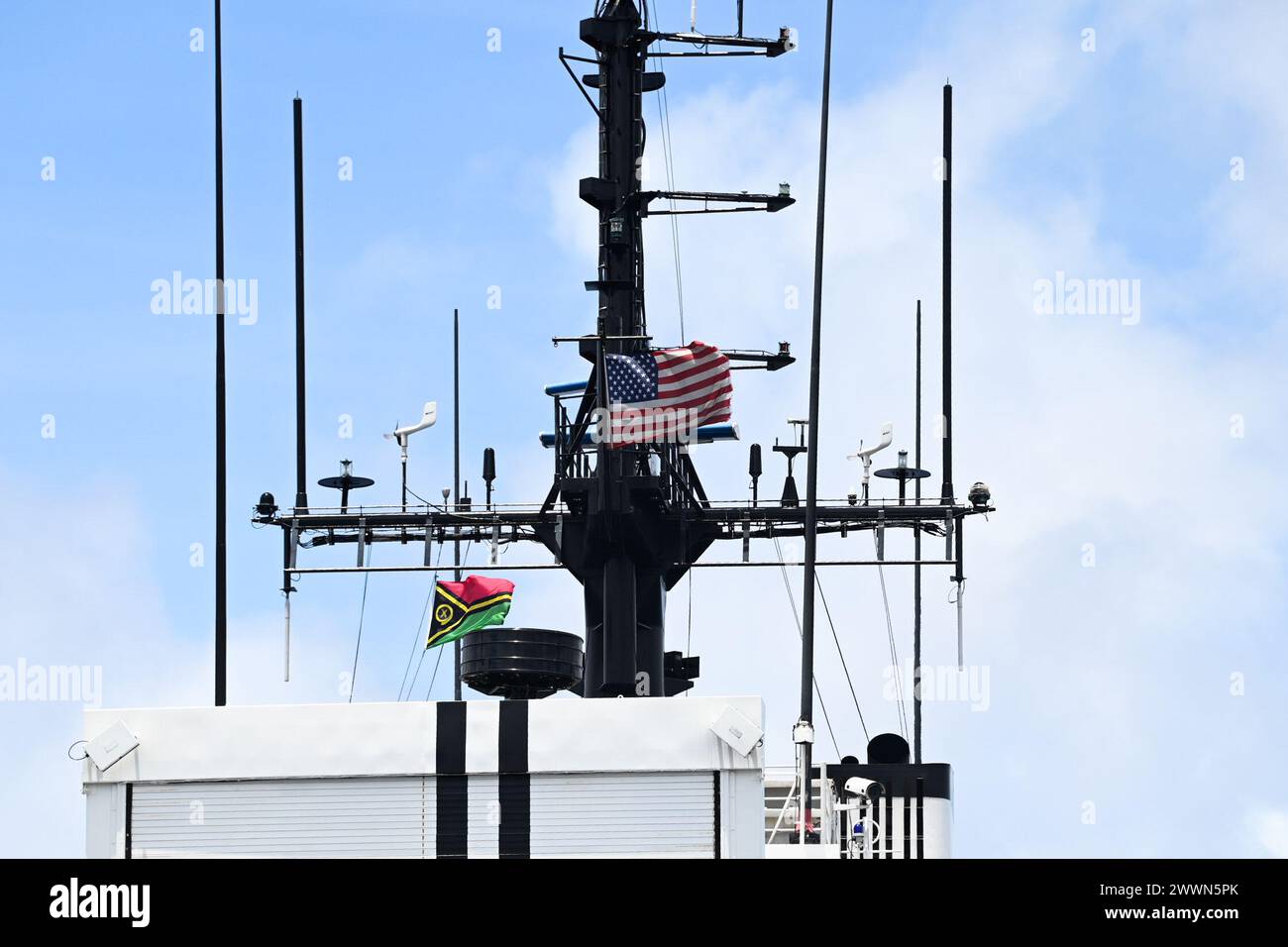 A U.S. flag and Vanuatu flag are flown together on the U.S. Coast Guard ...