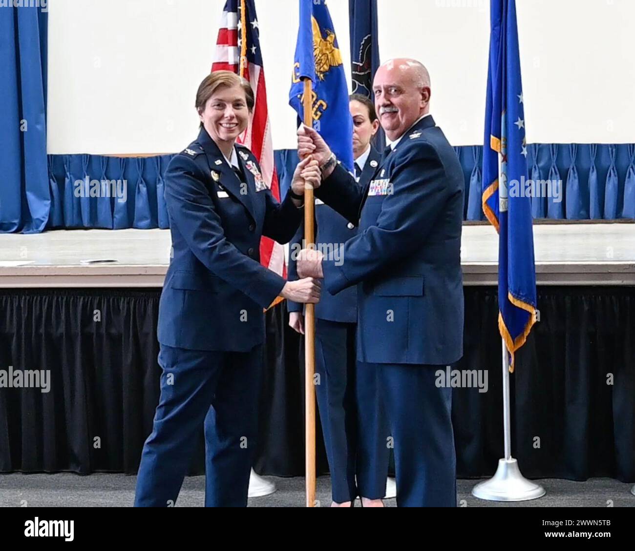 Col. Lynn Lee, 111th Attack Wing Commander, passes the unit colors to ...