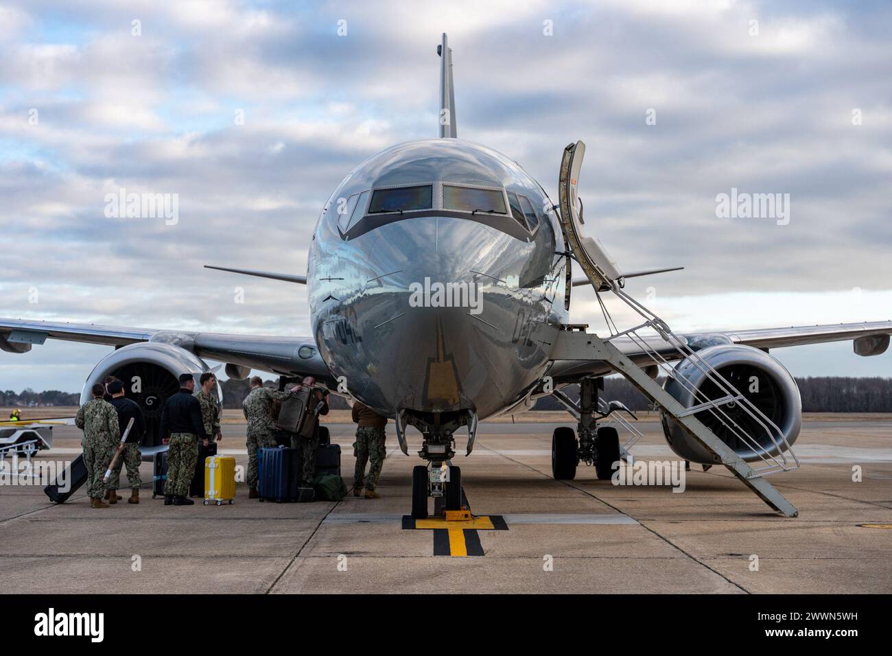 U.S. 2nd Fleet staff load luggage onto a Marine Corps C-40 aircraft ...