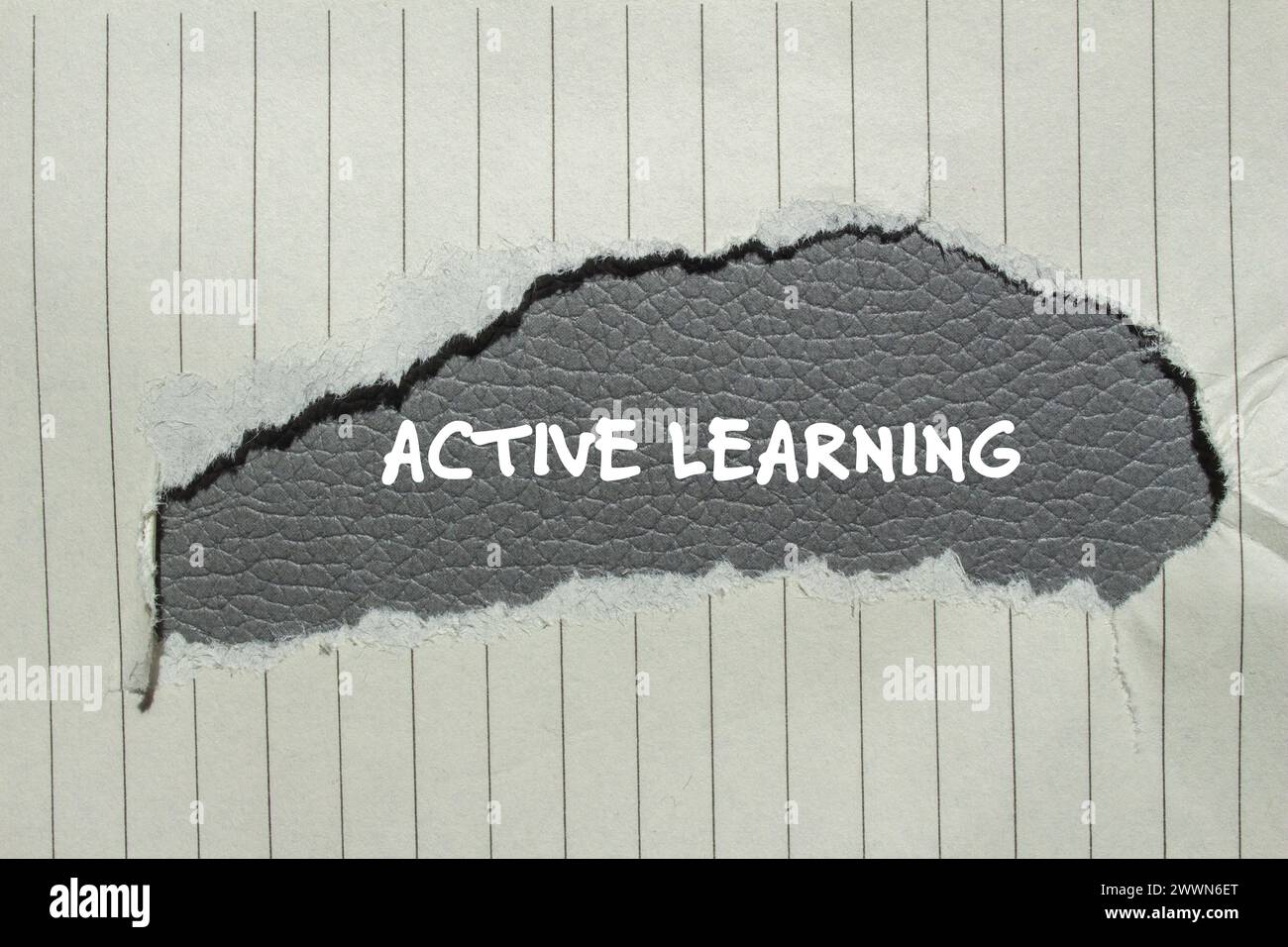 Active learning words written on torn paper with gray background ...