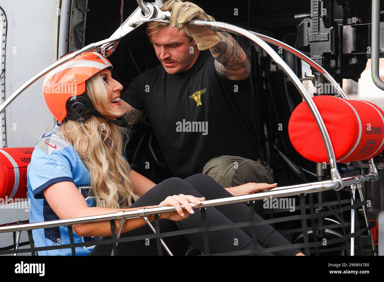 NFL cheerleader River Banks sits in a rescue basket during the Armed ...