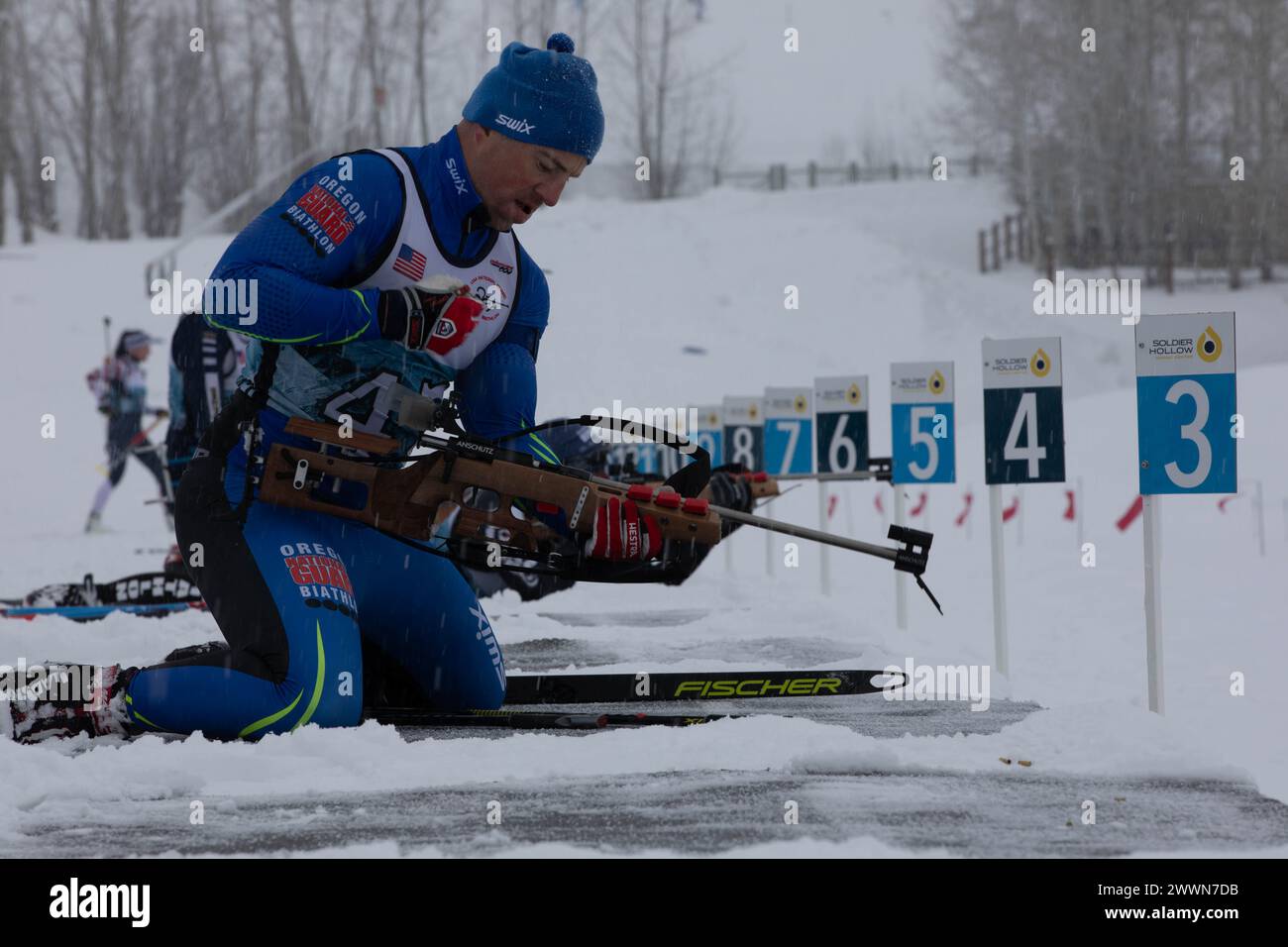 Cpt. Kyle Roe, Oregon National Guard, prepares his weapon for shooting ...