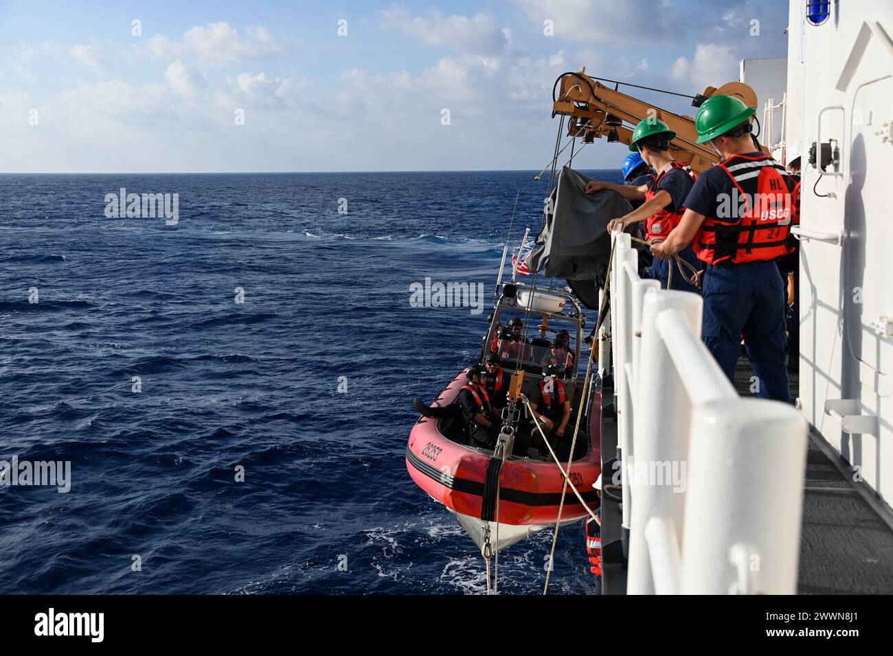 A U.S. Coast Guard Cutter Harriet Lane (WMEC) boat deck crew mans the ...