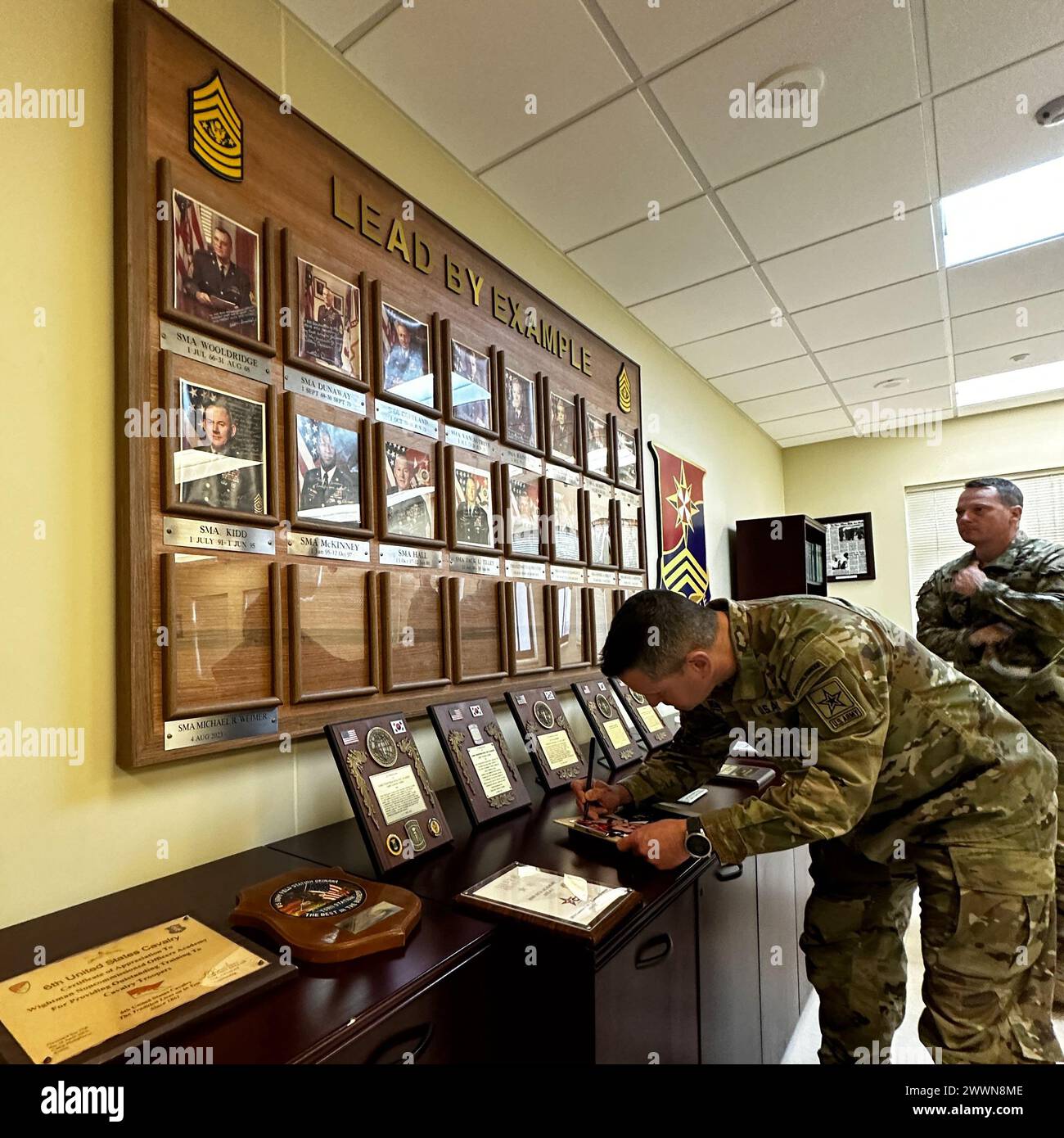 Sgt. Maj. of the Army Michael Weimer signs a visitor's log at the ...