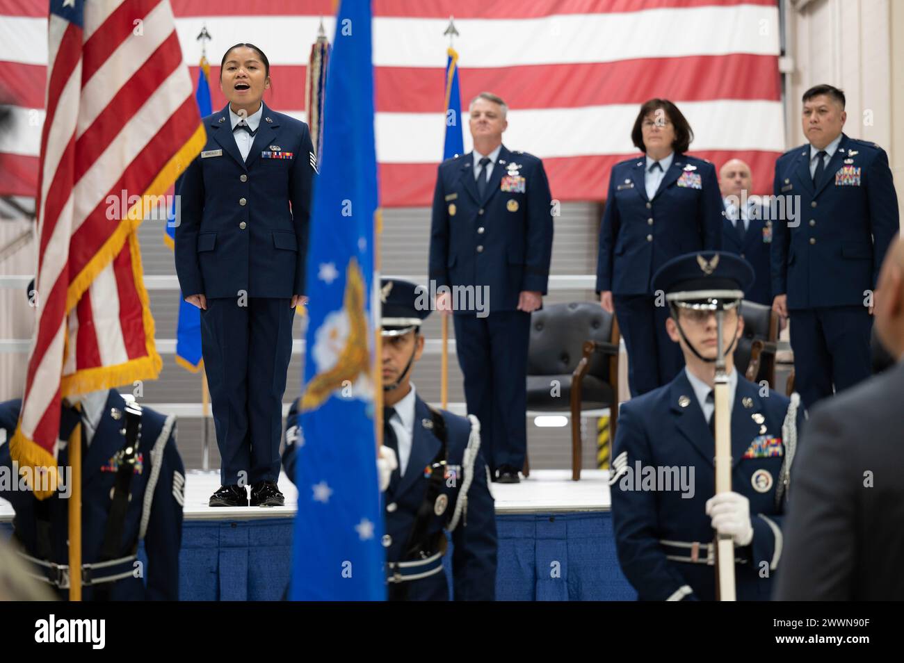 Staff Sgt. Rosalyn Gonzalez sings the national anthem during a change ...