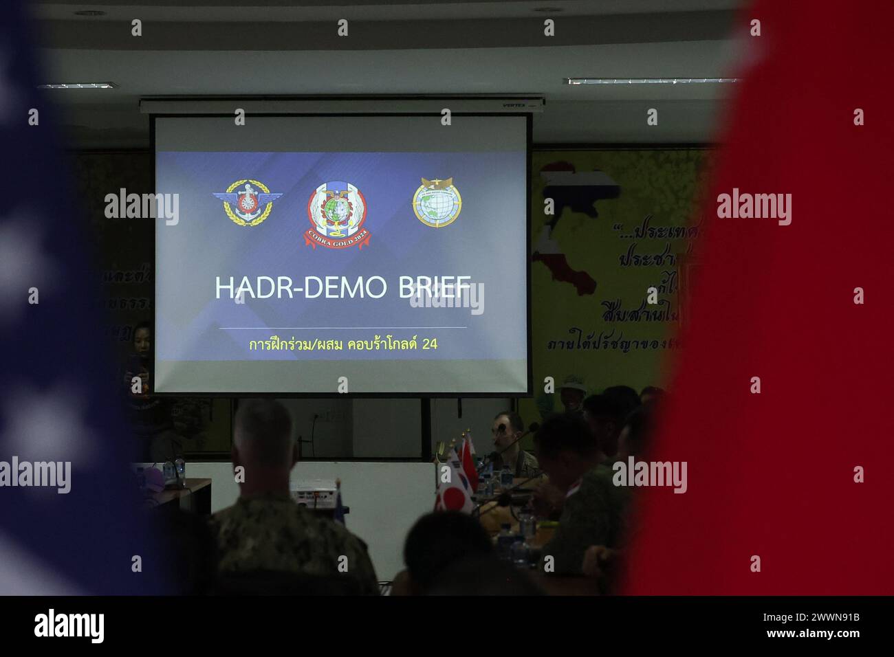 Service members from nine participating nations listen to a brief ...