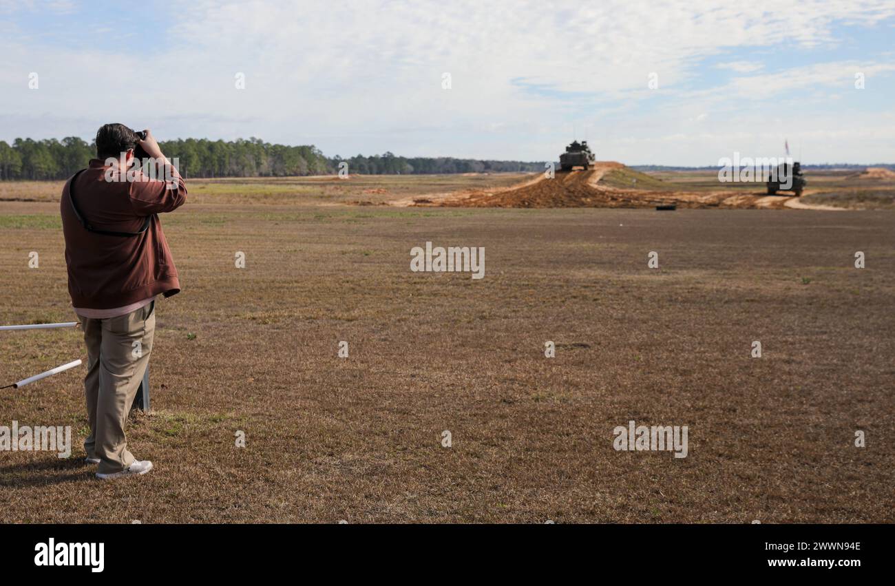 Joseph Cooper, a garrison public affairs photographer, takes photos at ...
