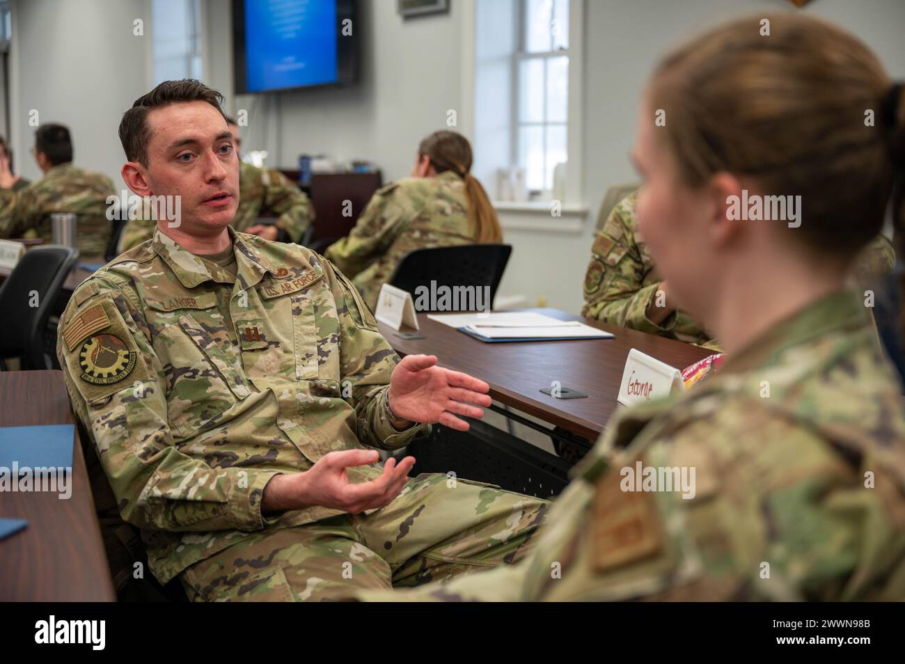 A classroom of officers practice their communication skills with a ...