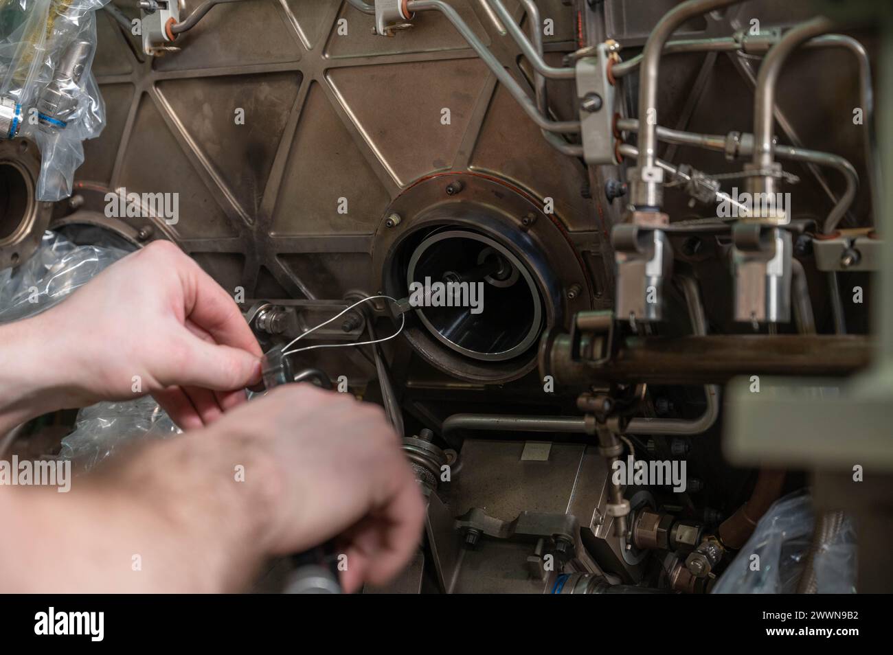 U.S. Airman performs daily maintenance on an F100-PW-220 jet engine at ...