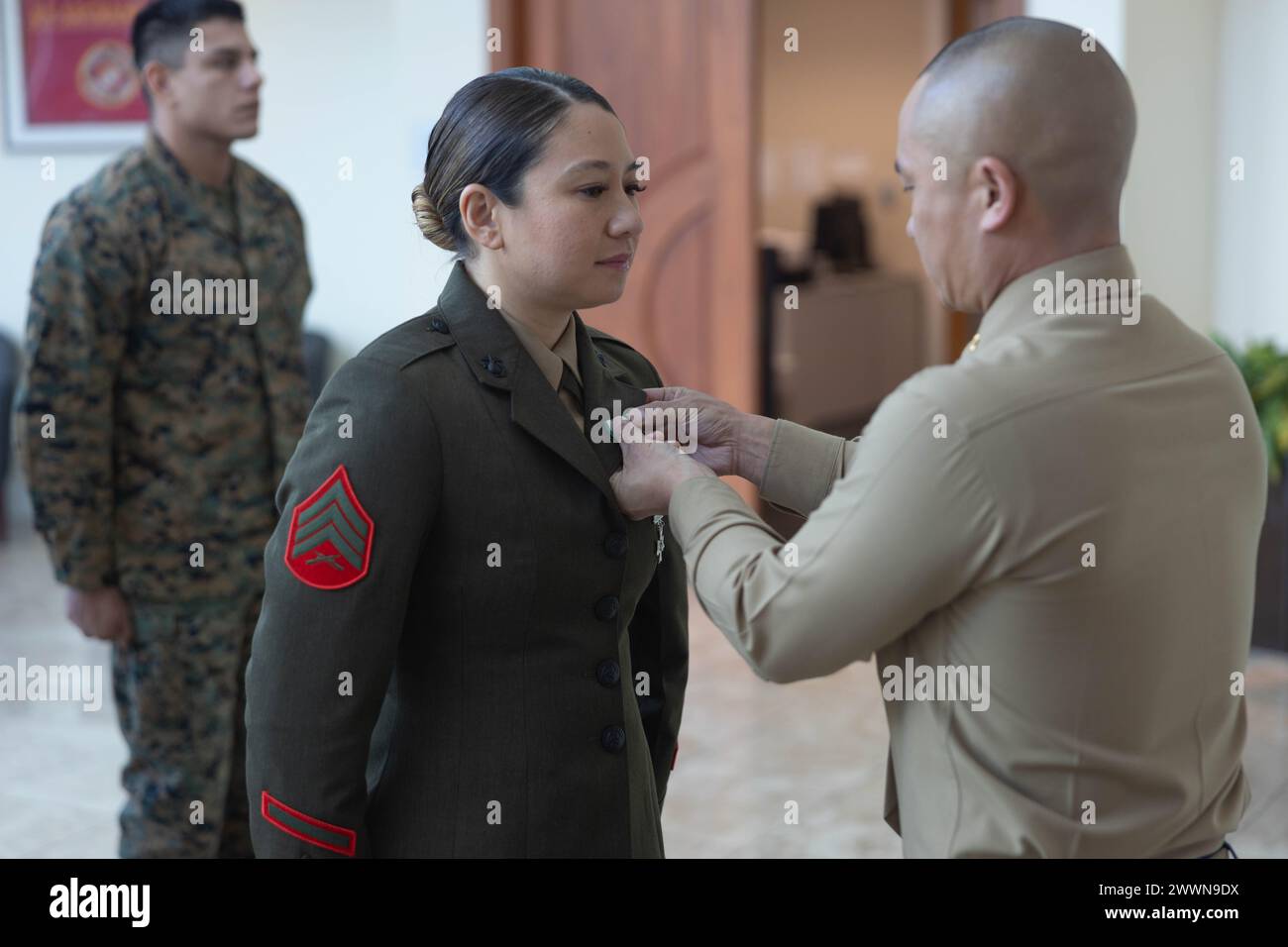 U.S. Marine Corps Sgt. Seaira Moore receives a Navy and Marine ...