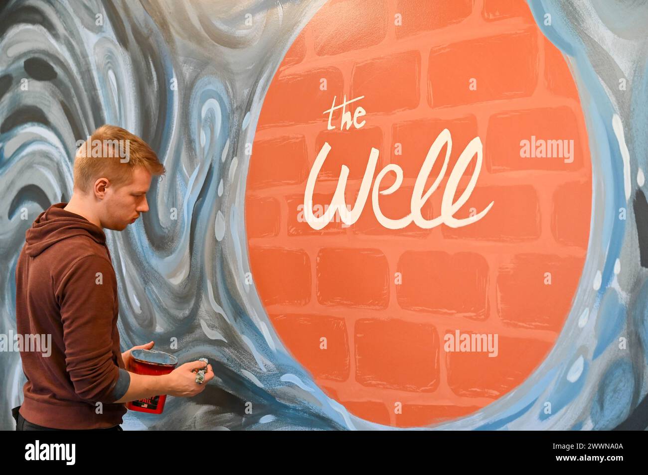 Adam Boggs, a Nebraska freelance illustrator, paints a mural in The ...
