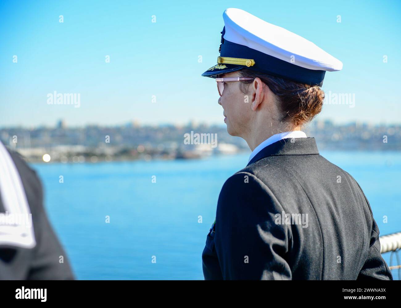 U.S. Navy Cdr. Cheryl Collins, from Cumming, Georgia, mans the rails as ...