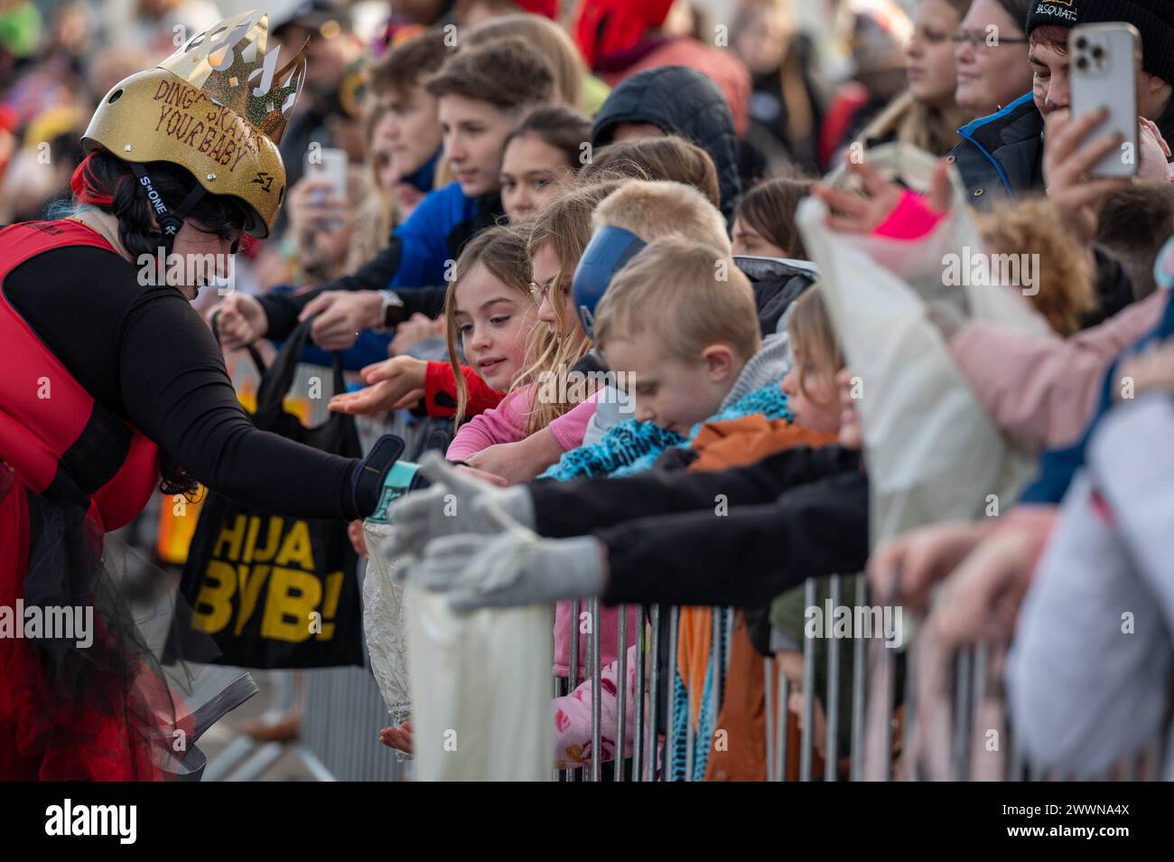 A parade participant passes out candy to children in the crowd during ...