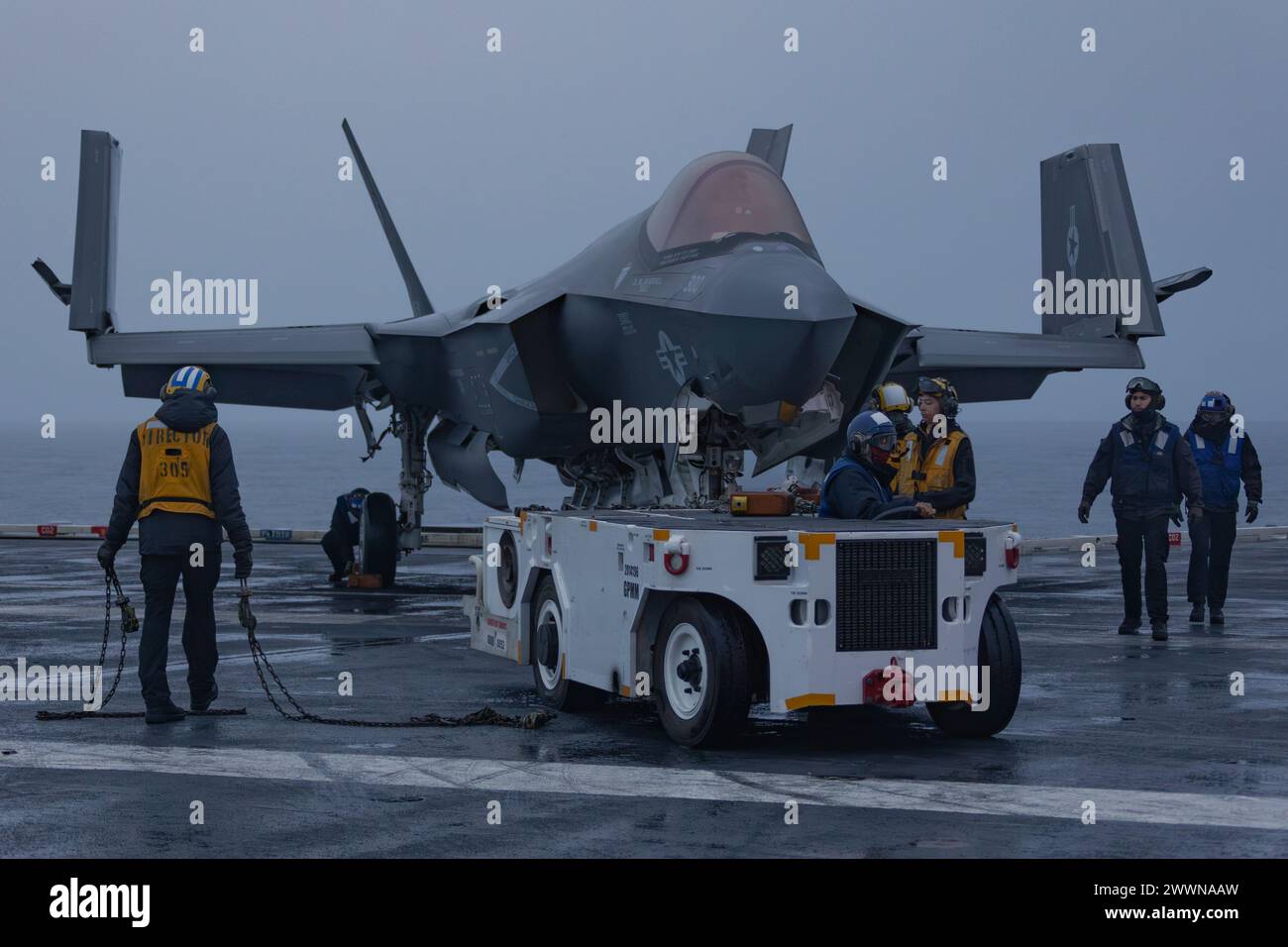 240205-N-LM220-1199 PACIFIC OCEAN (Feb. 5, 2024) Sailors chock and chain an F-35C Lightning II ...