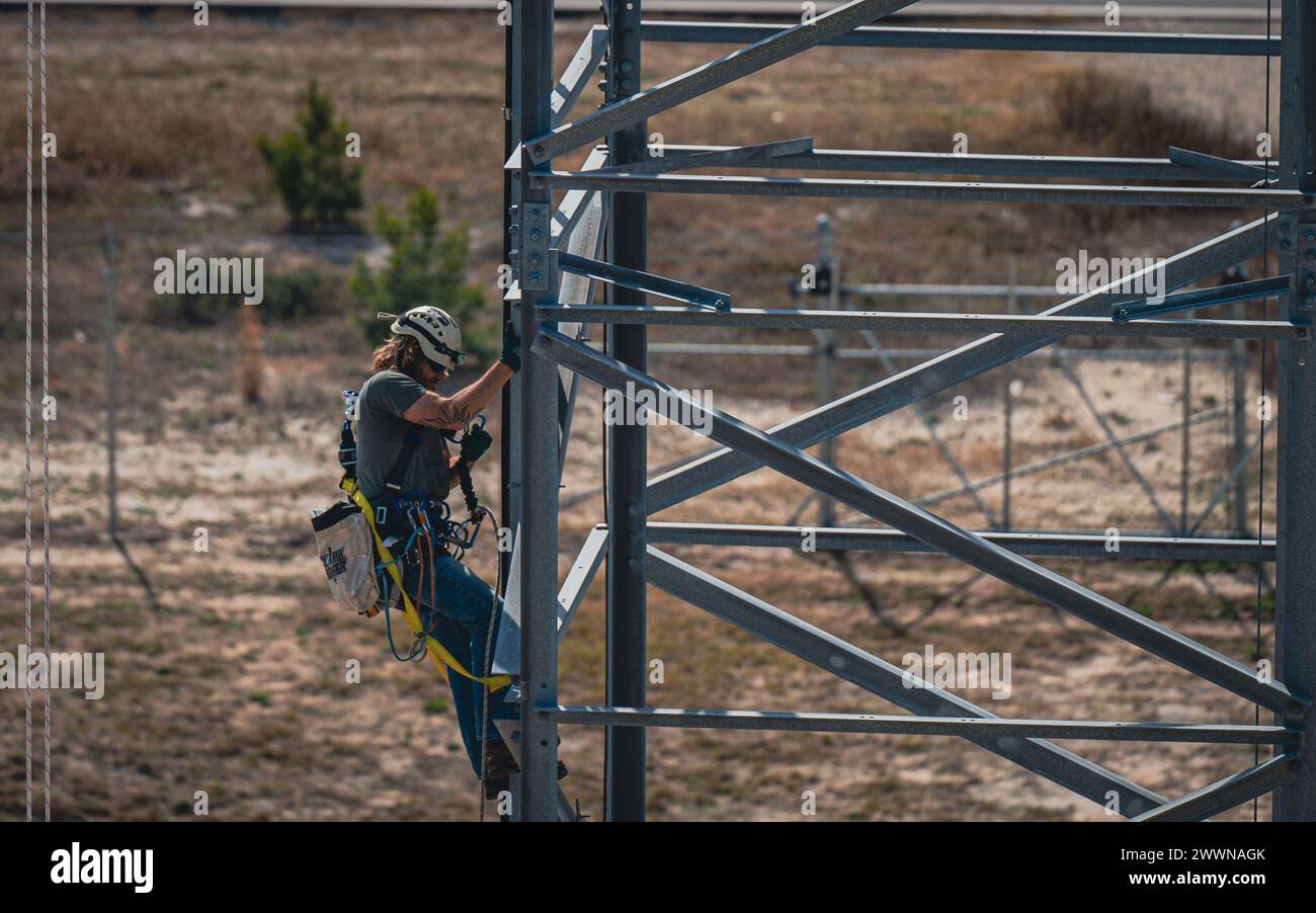 Jacob Sels, radio frequencies technician, climbs a Ground Air Transmit ...