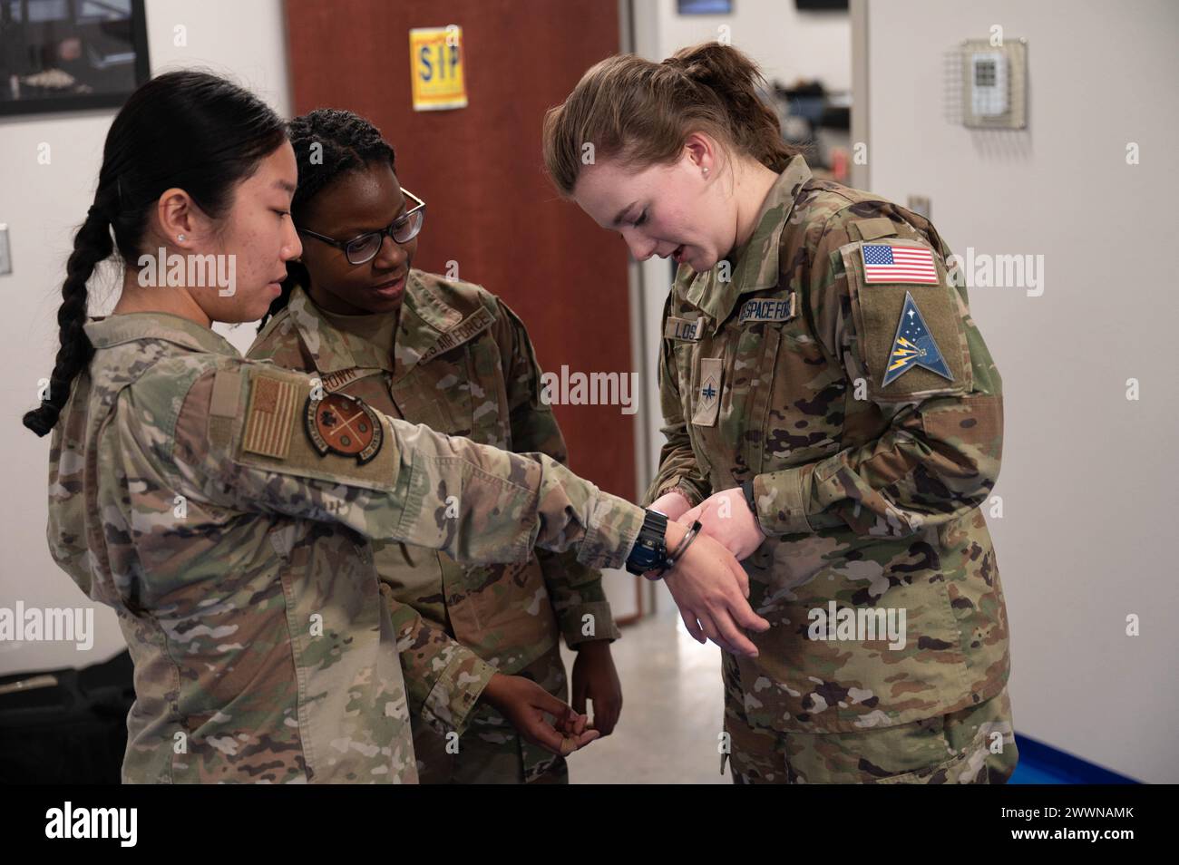Three Security Forces augmentees participate in handcuff training on ...