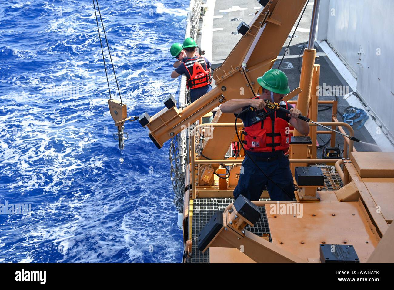 A U.S. Coast Guard Cutter Harriet Lane (WMEC 903) boat deck crew wash ...