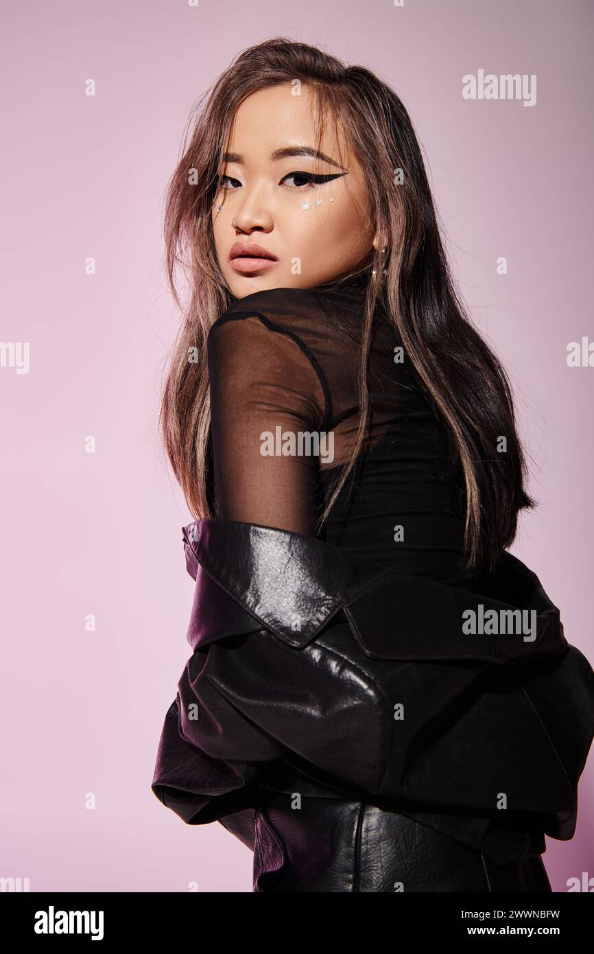 attractive asian woman in 20s with daring makeup looking to camera from ...