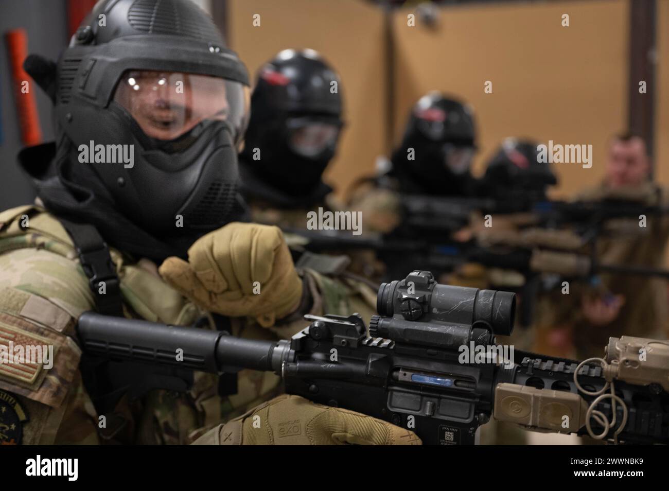 A member of the 710th Security Forces Squadron pulls back the charging ...