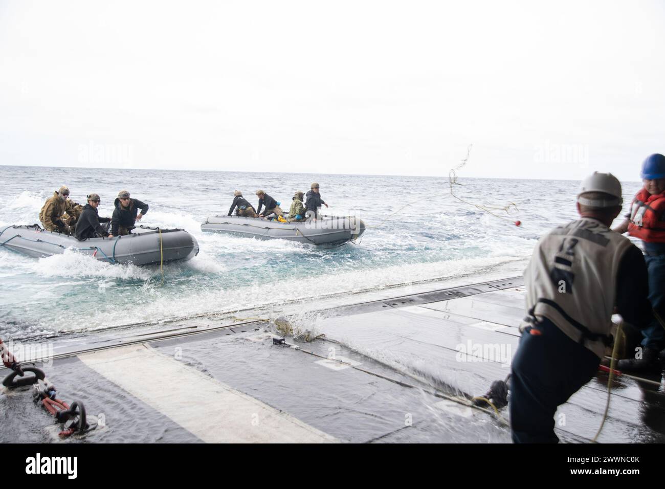 U.S. Navy Sailors receive combat rubber raiding craft in the well deck ...