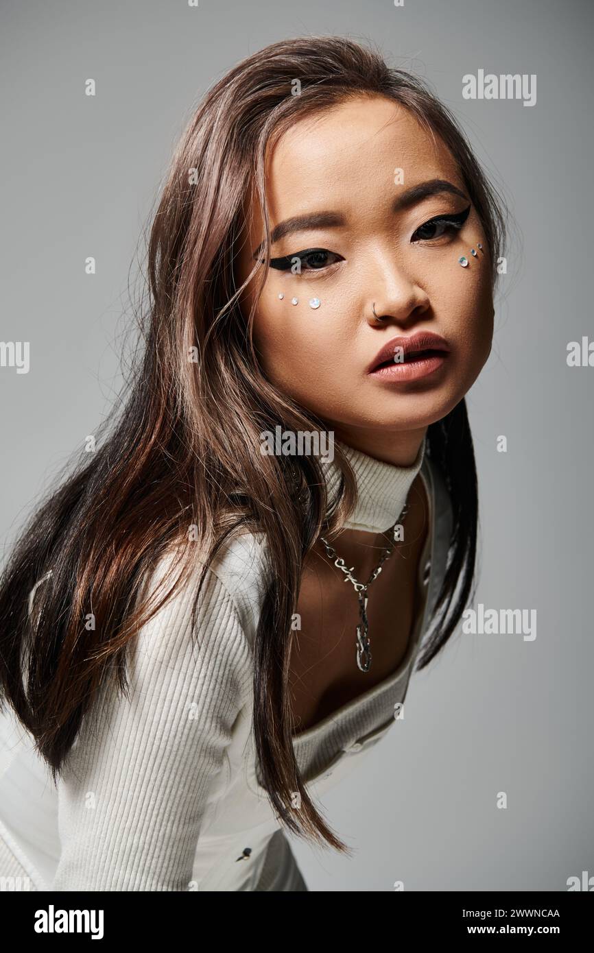 attractive asian woman in 20s with heavy makeup sideways leaning ...