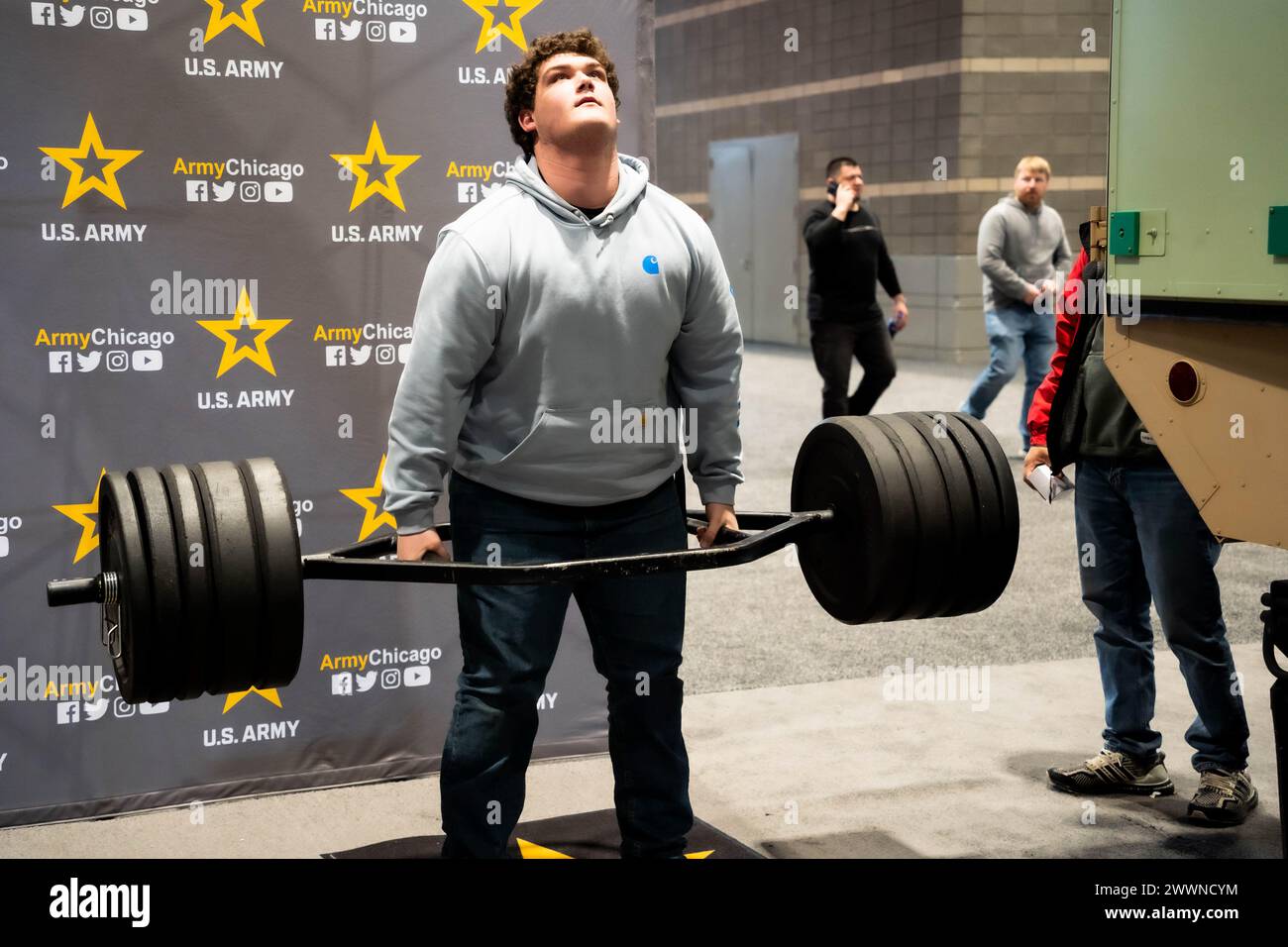 A spectator lifts 340 pounds five times during the Chicago Auto Show at ...