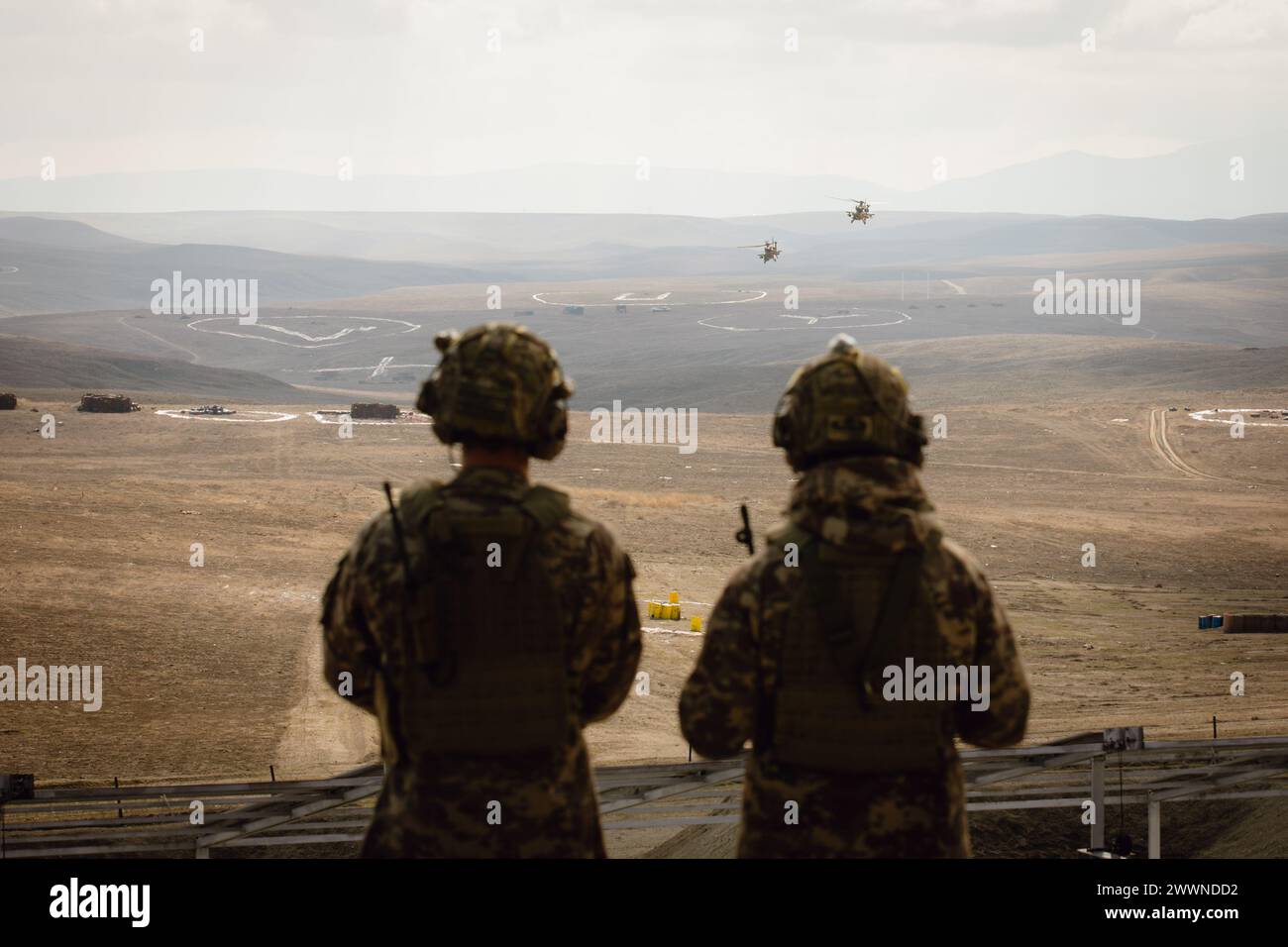 Turkish Defense Forces service members look out at Turkish T-129 ...