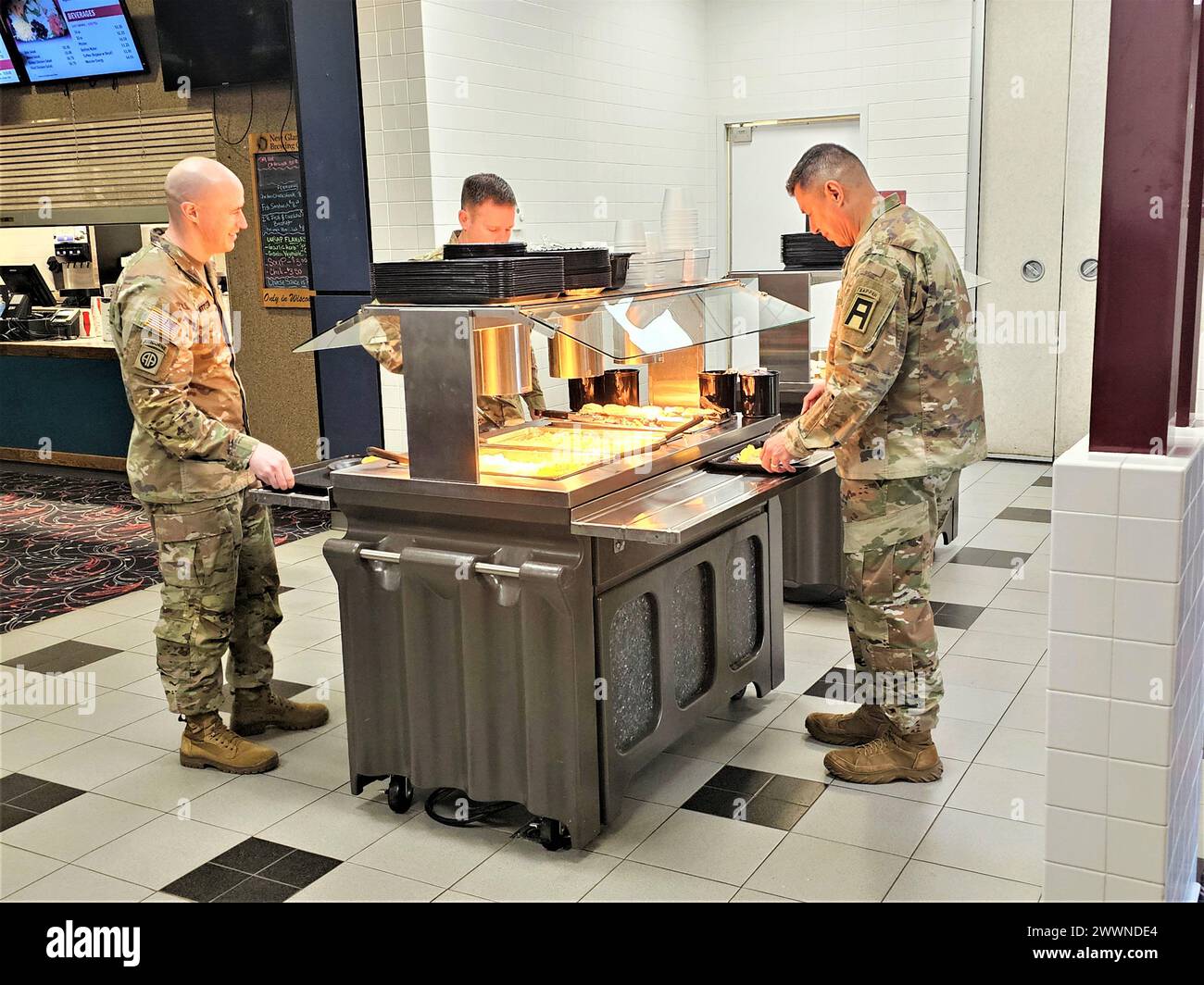 Event-goers fill their plates with breakfast menu items during the 2024 ...