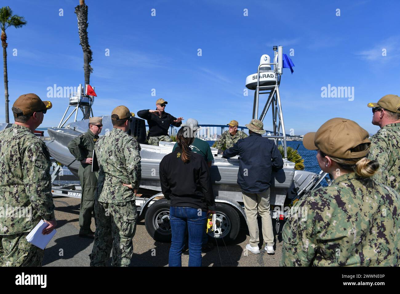 NAVAL BASE CORONADO (Feb. 15, 2024) Capt. Derek Rader, center, shows ...