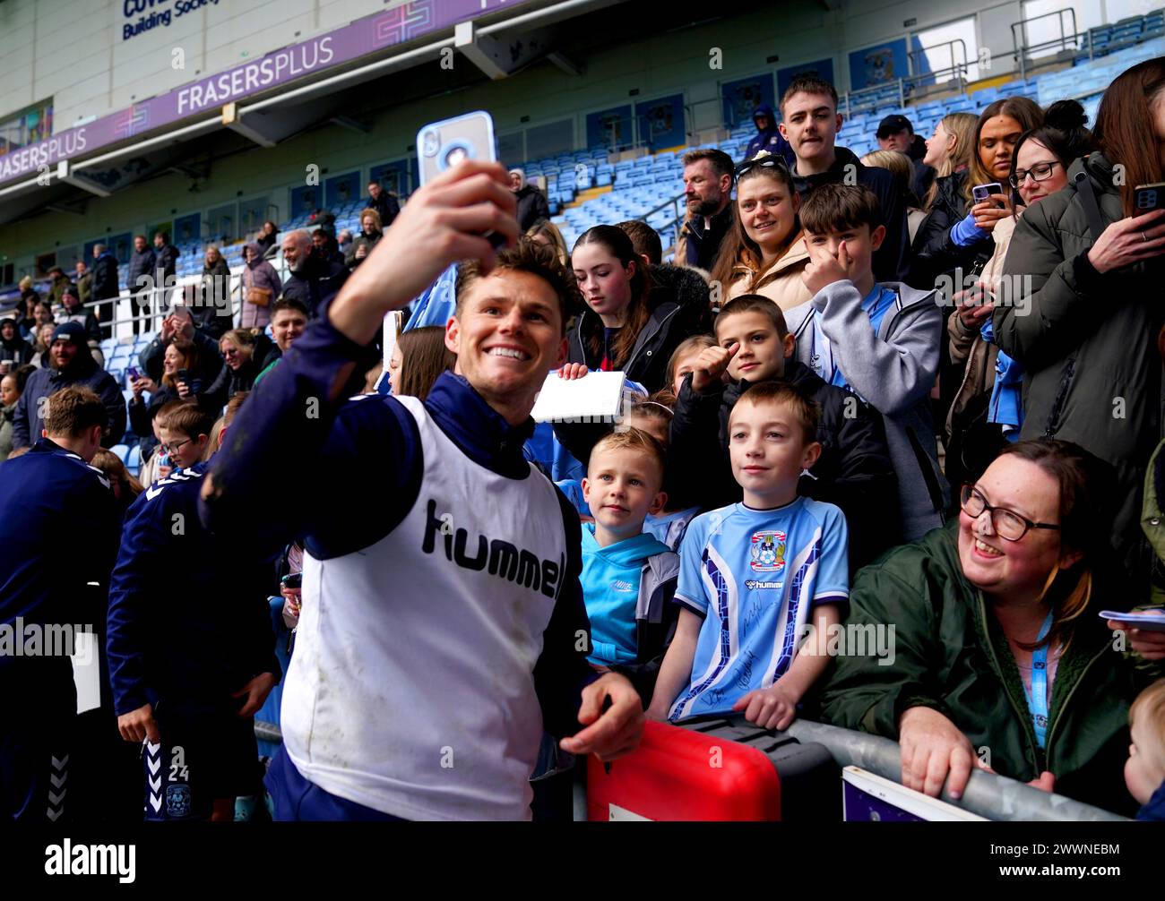 Coventry City goalkeeper Ben Wilson takes a photo with fans after a ...