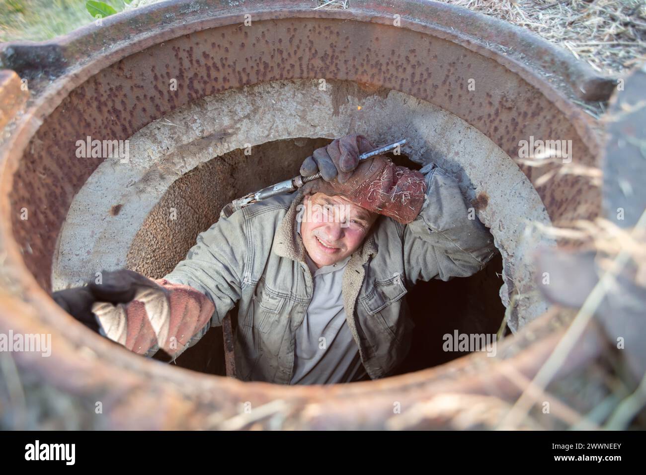 Sewage works. Industrial wastewater treatment. A worker in a sewer ...