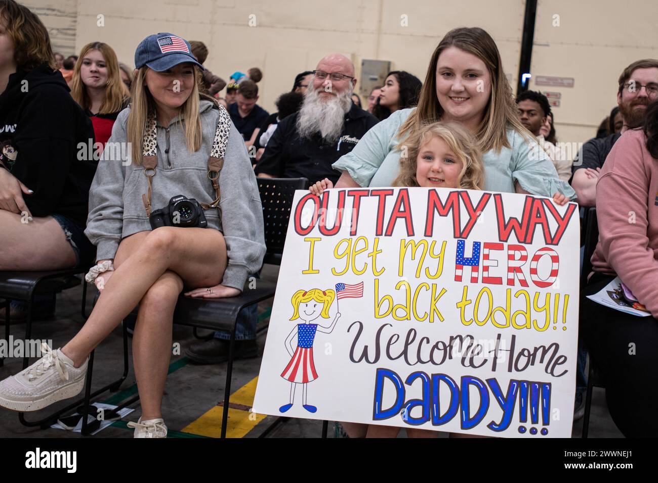 The family of a Task Force Tomahawk member holds up a sign at the Task ...