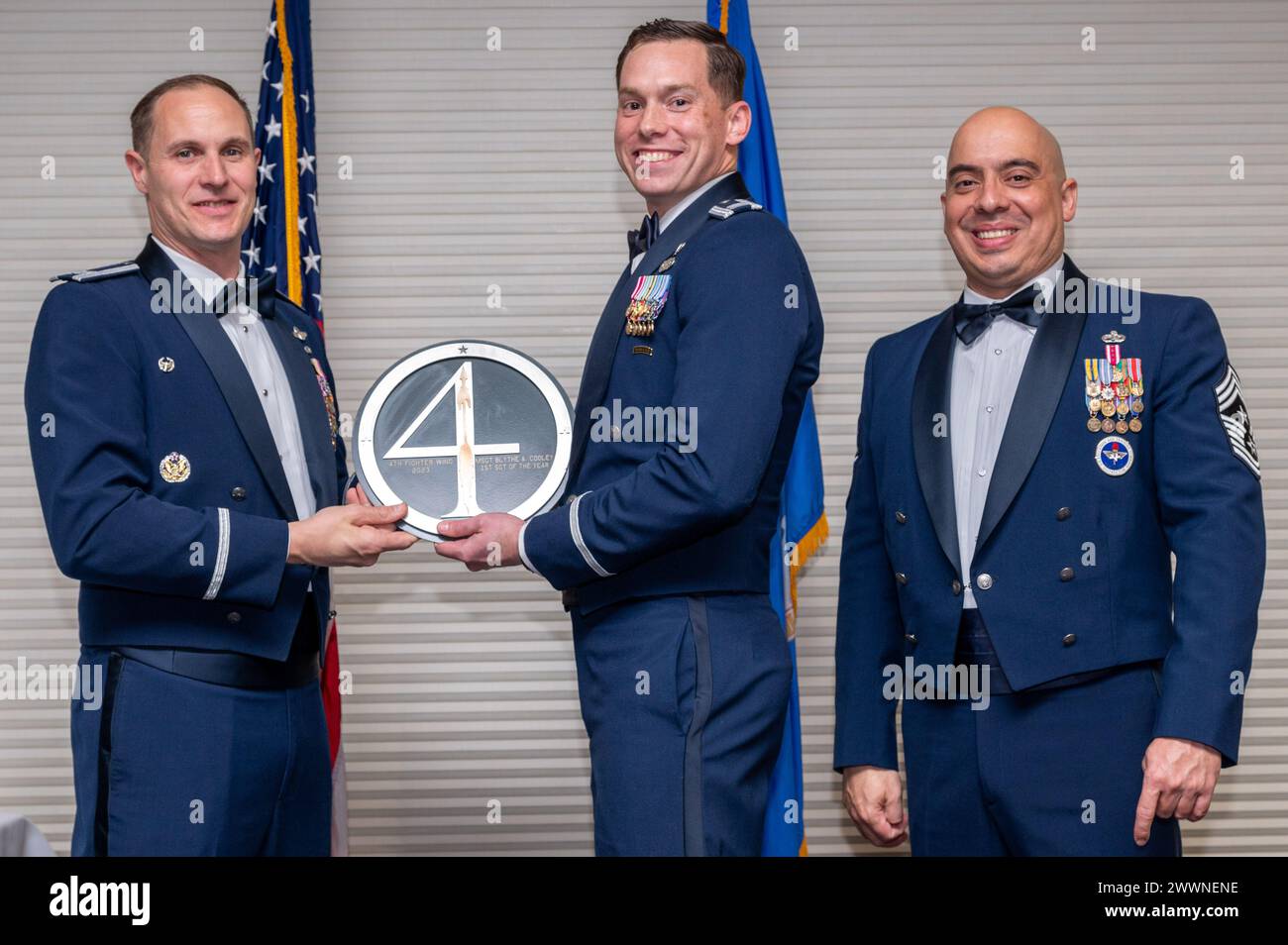 Master Sgt. Blythe Cooley, center, 4th Security Forces Squadron First Sergeant, receives the ...
