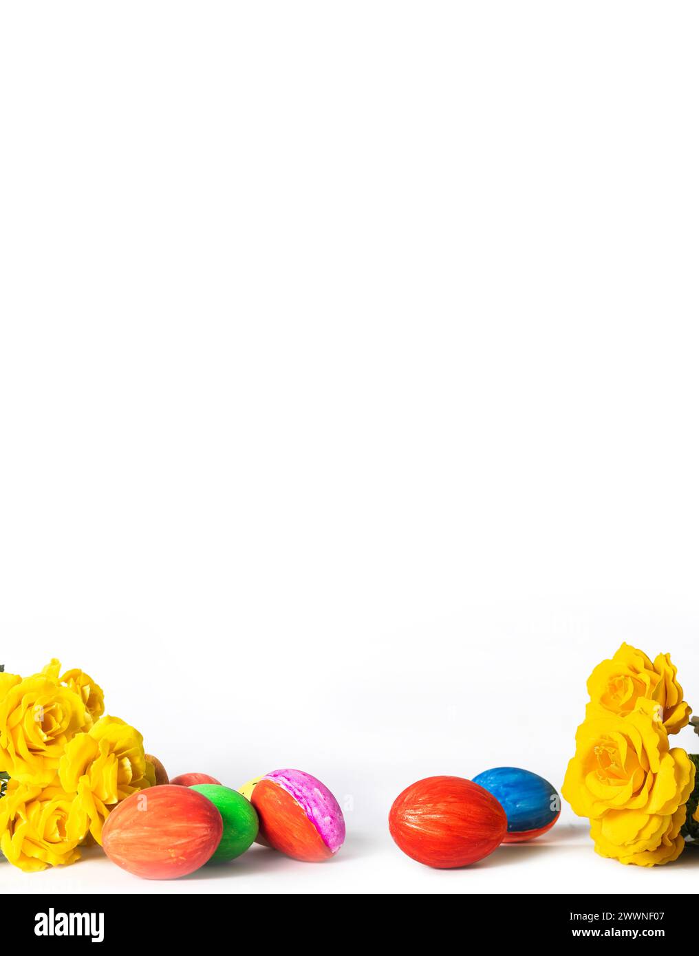 Easter eggs and yellow roses on white background with copy space for ...