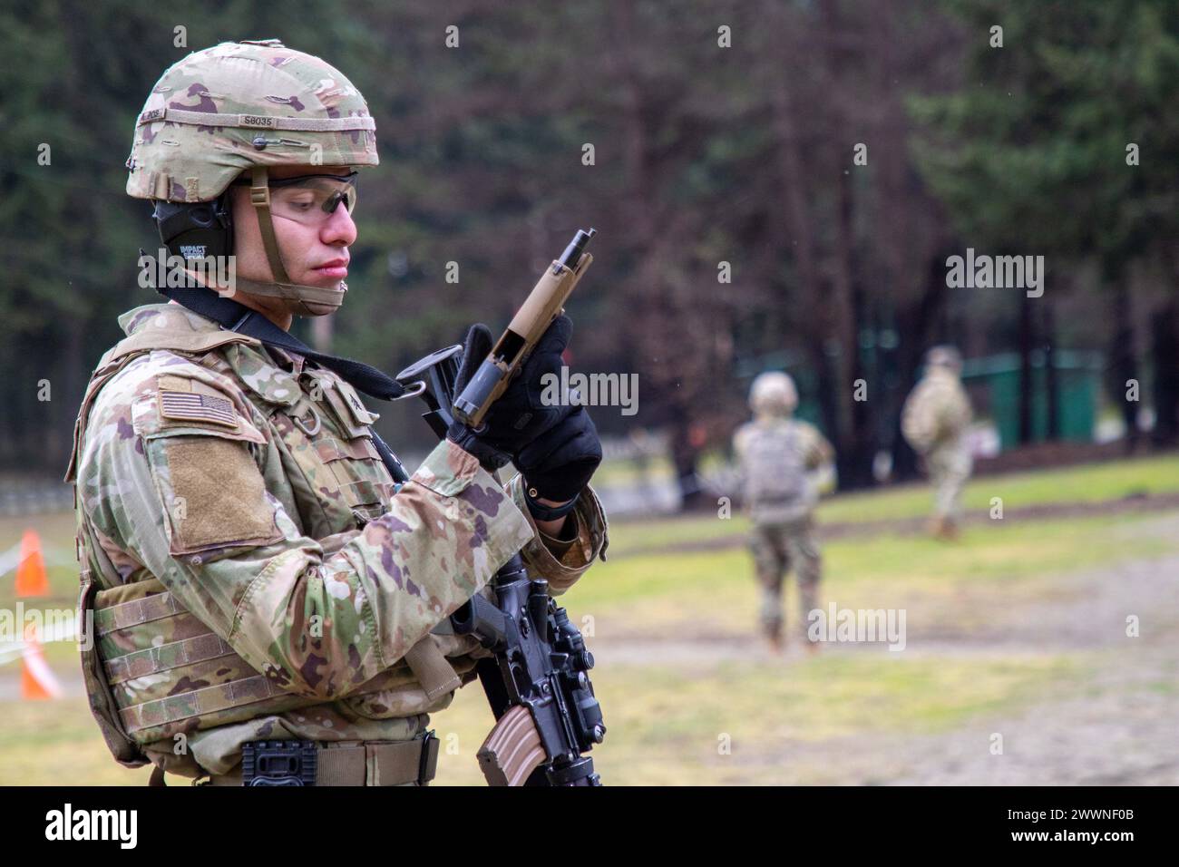 Sgt. Edgardo Suarez, assigned to 42nd Military Police Brigade, loads a ...