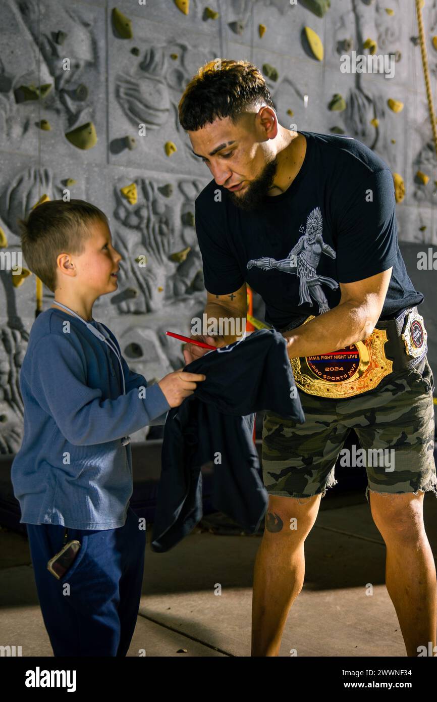 Steven Gurrola, right, an amateur fighter with The MMA Lab, gives a ...