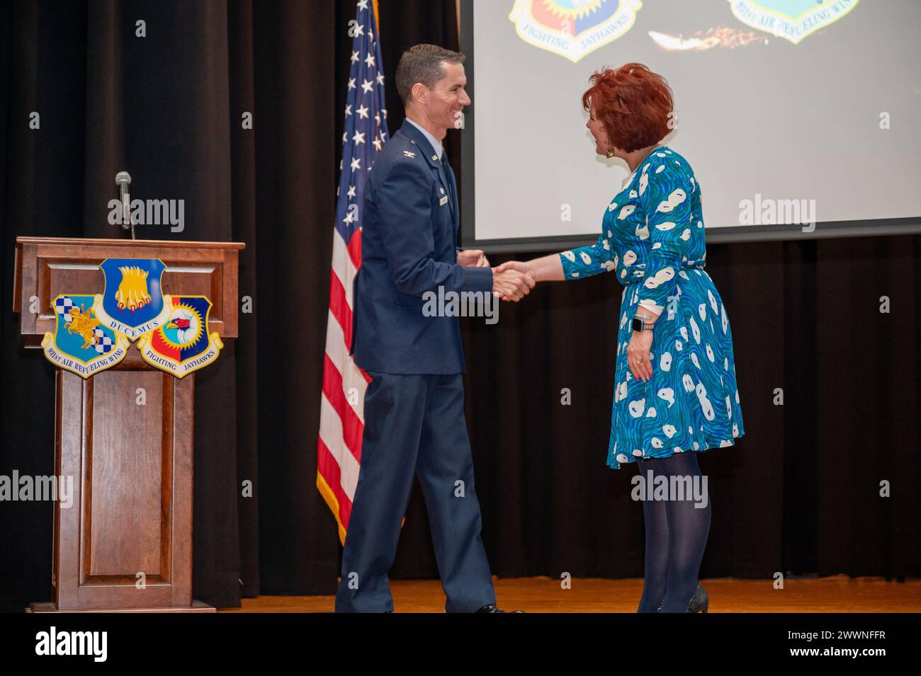 Col. Cory Damon, 22nd Air Refueling Wing commander, shakes hands with ...