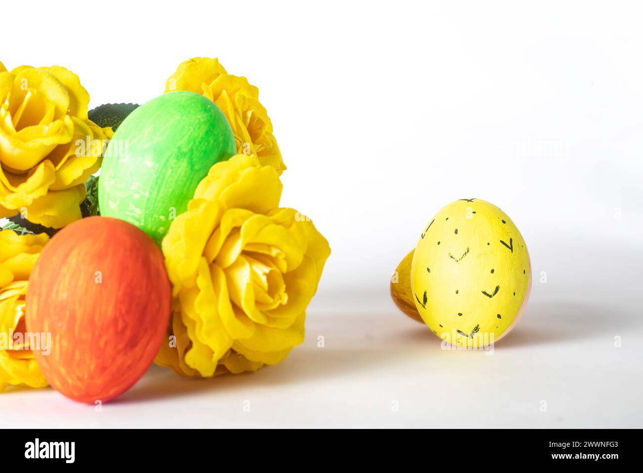 Easter eggs and yellow roses isolated on white background with copy ...