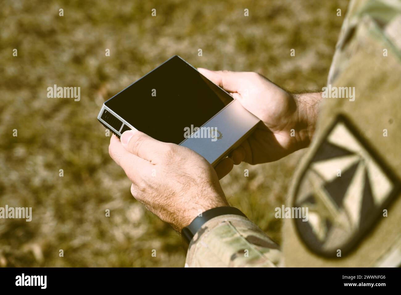 A Soldier demonstrates the use of a portable rapid diagnostic tool for ...