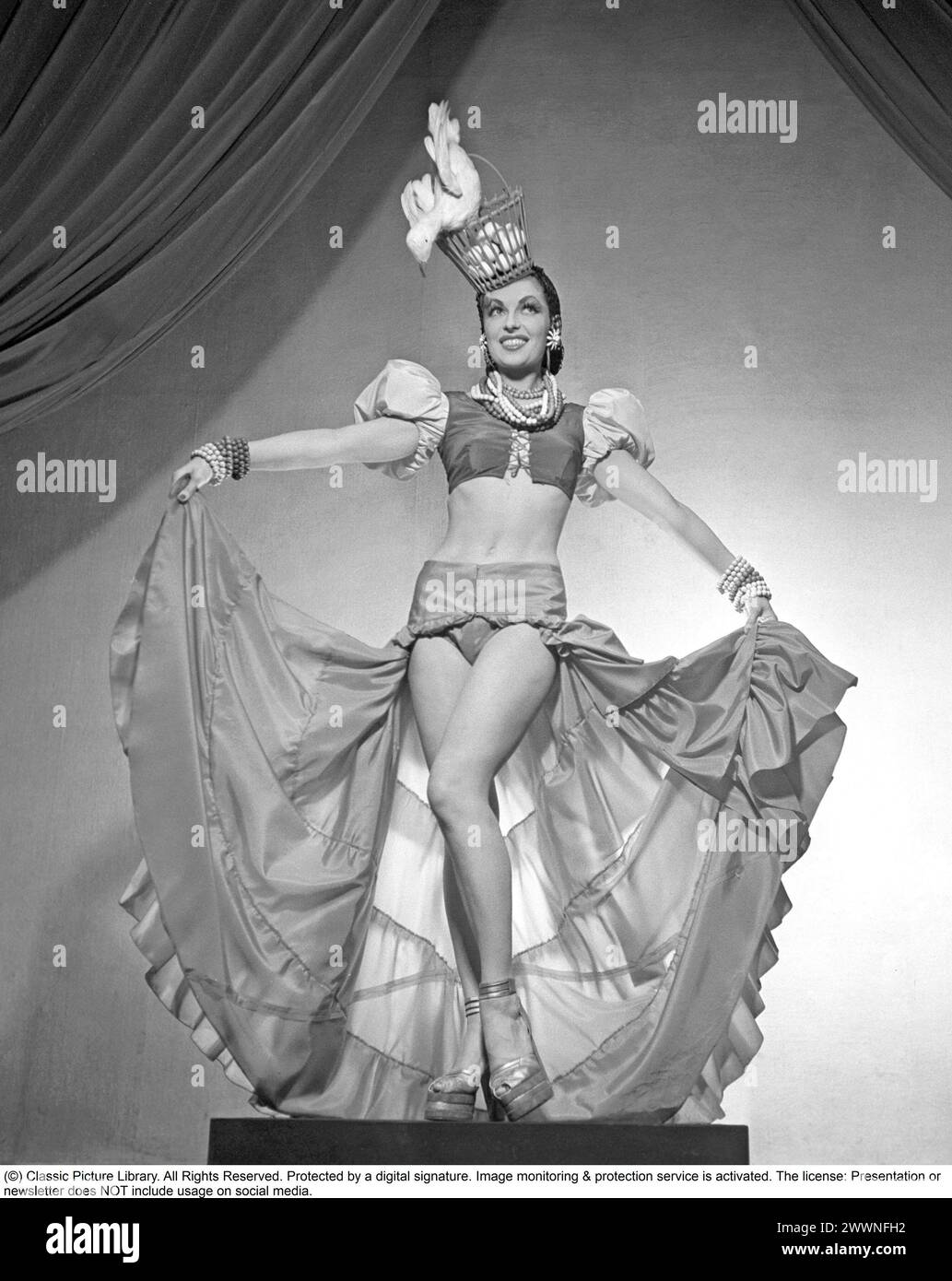 Showgirl in the 1940s. A beautiful looking actress and dancer pictured on the theater stage ...