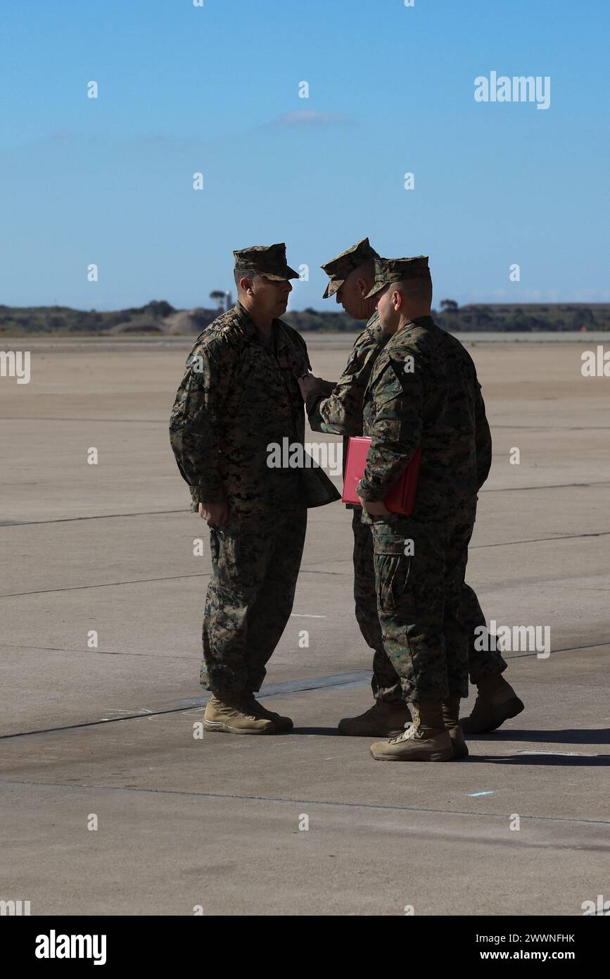 U.S. Marine Corps Col. Jason P. Quinter, middle, the commanding officer ...