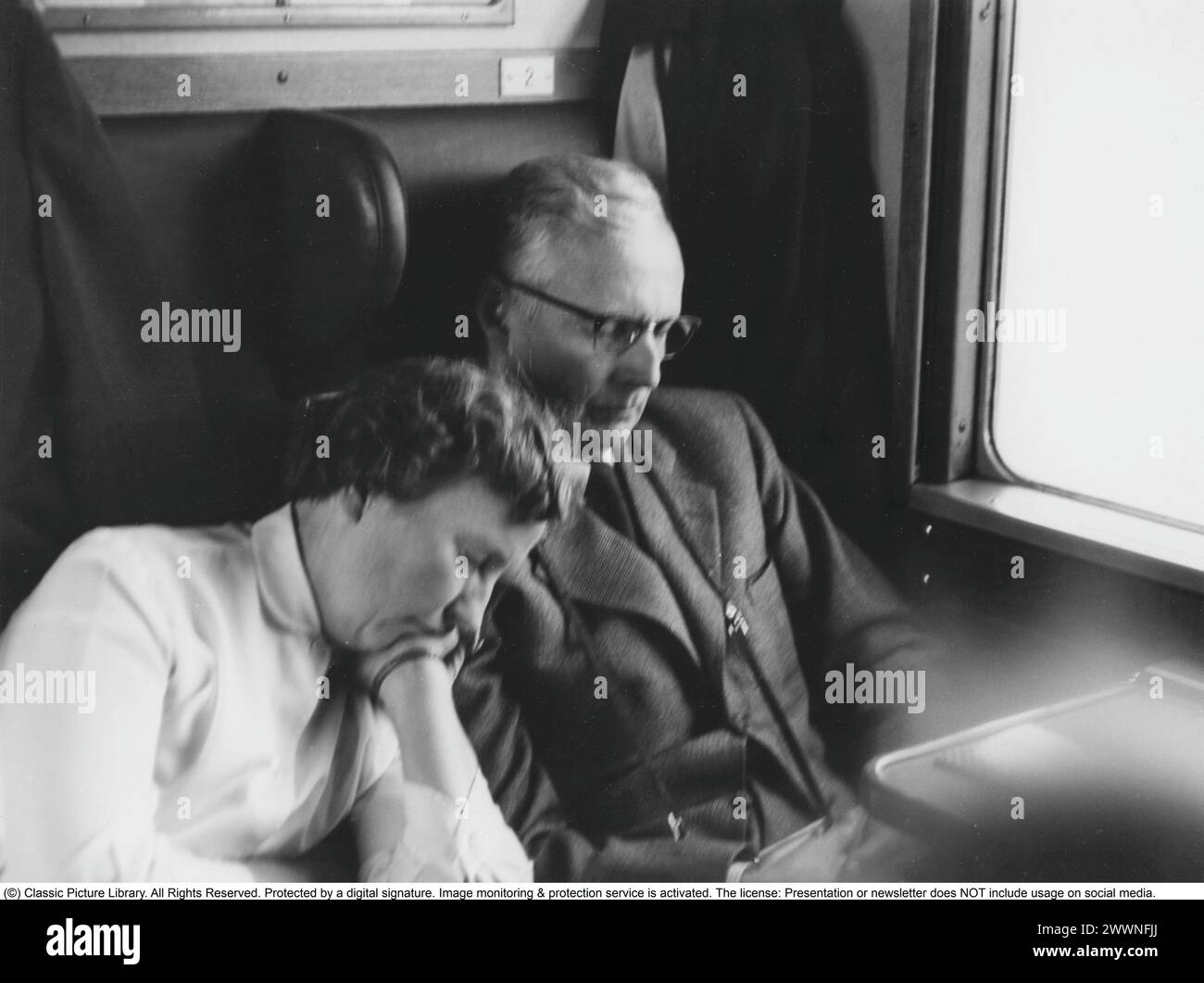 Train travel in the 1940s. A man and a women seen sleeping onboard a ...