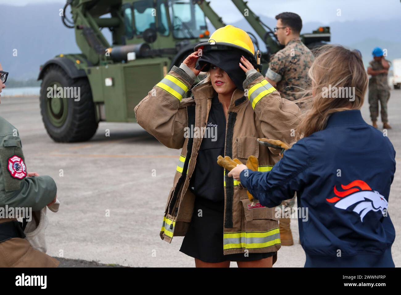 NFL cheerleader Whitney Schutt dons crash fire rescue equipment during ...