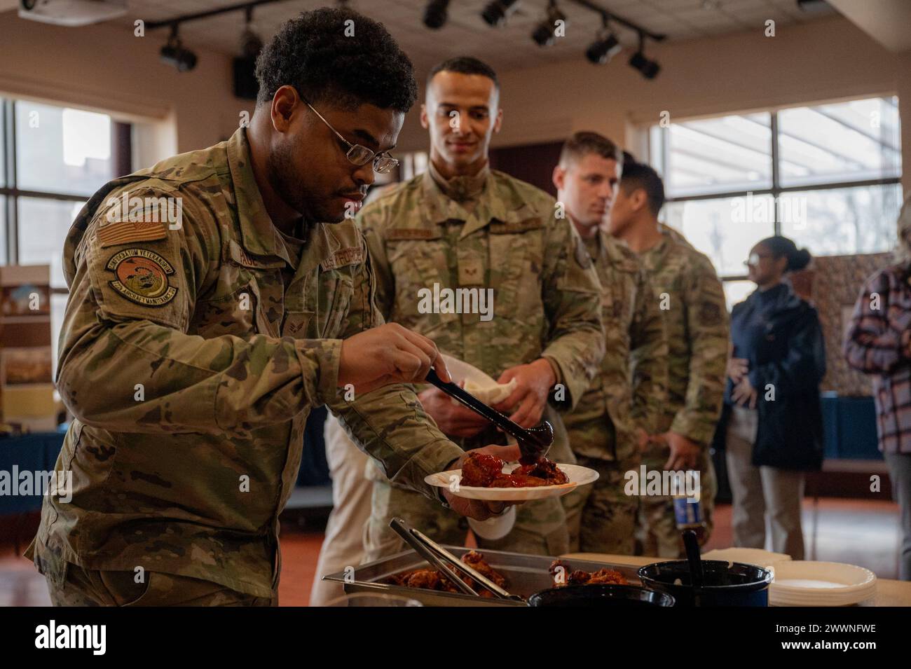 22nd Air Refueling Wing Airmen load their plates with chicken wings Feb ...