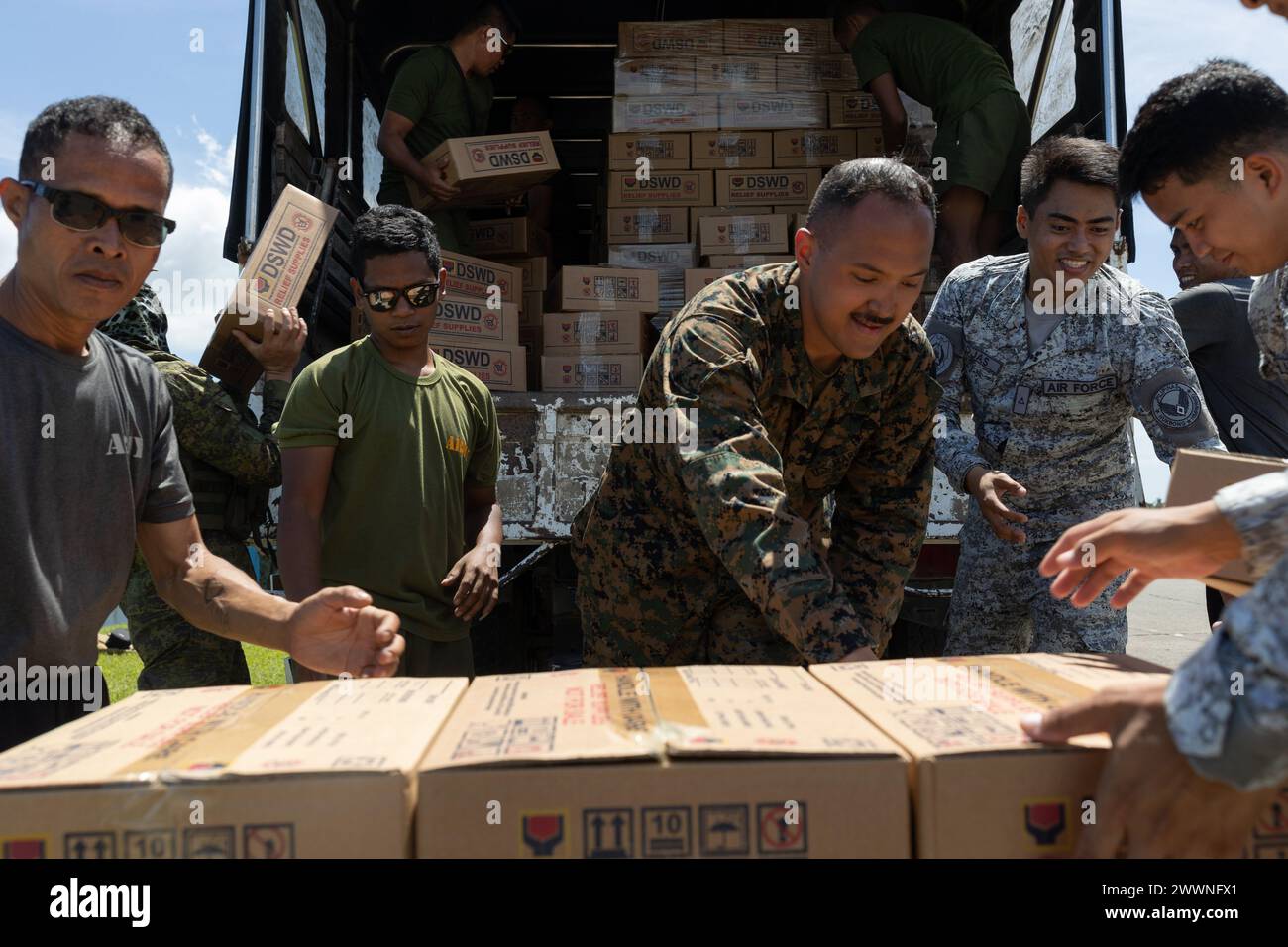 U.S. Marine Corps Cpl. Raphael Viray, center, an aviation supply ...