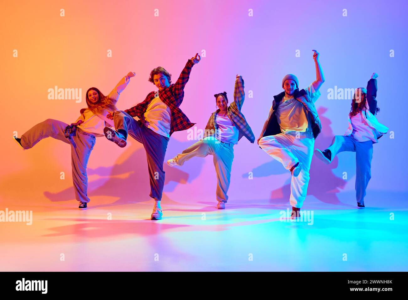Dynamic performance of five talented dancers in motion, dancing modern ...