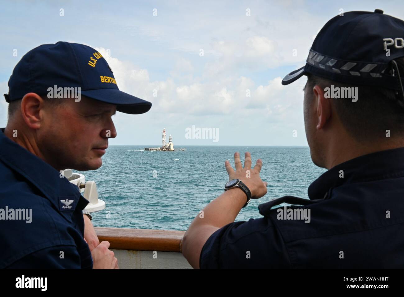 A member of the Singapore Police Coast Guard speaks with Capt. Billy ...