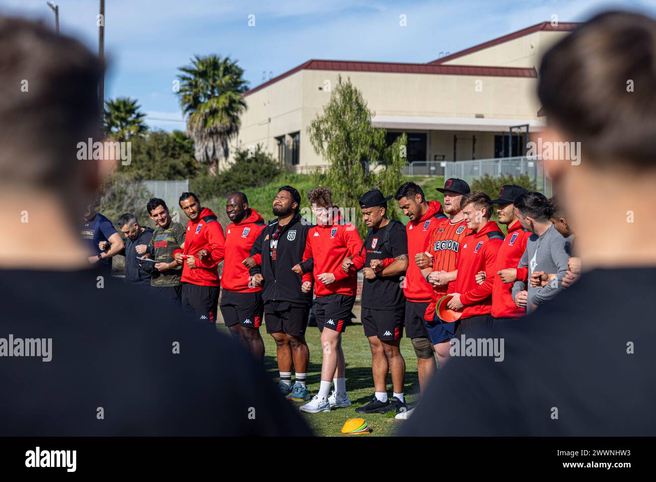Members of the San Diego Legion rugby team lock arms alongside U.S ...