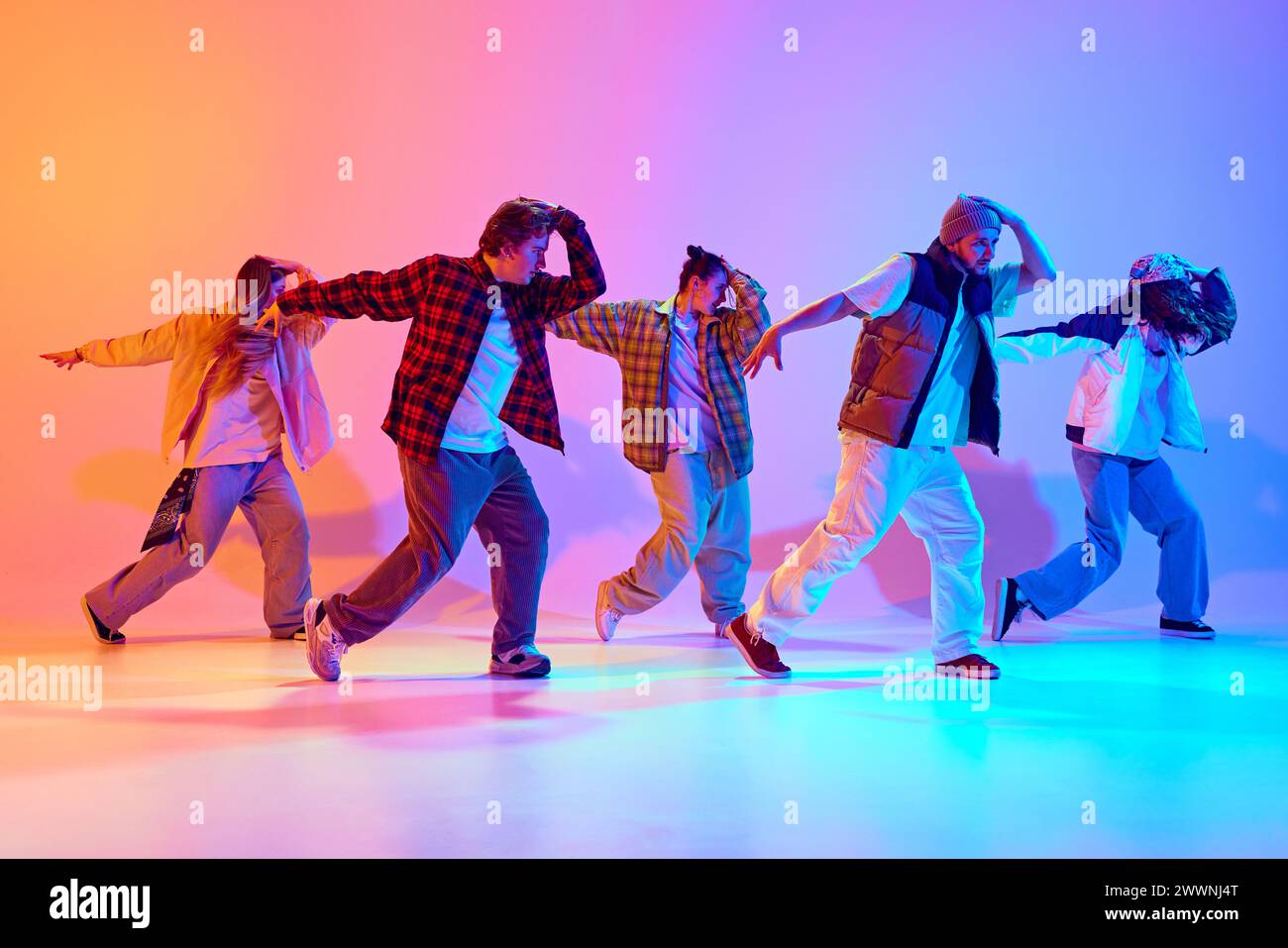 Dynamic performance of five talented dancers in motion, dancing modern ...